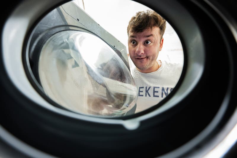 Man View from Washing Machine Inside. Male Does Laundry daily Routine ...