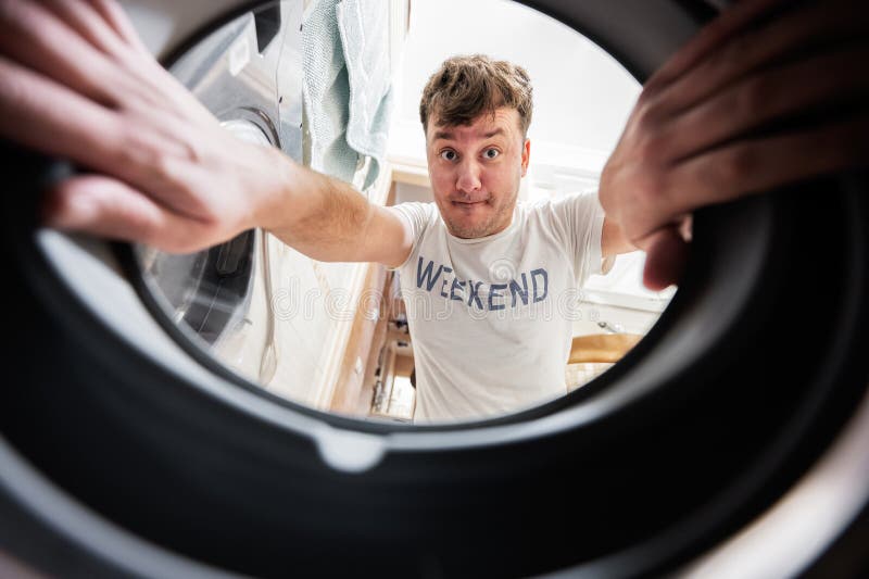Man View from Washing Machine Inside. Male Does Laundry daily Routine ...