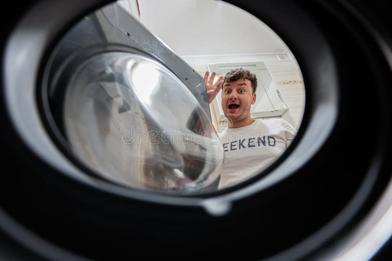 Man View from Washing Machine Inside. Male Does Laundry daily Routine ...