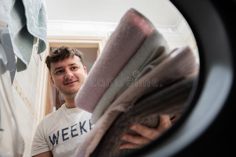 Man View from Washing Machine Inside. Male Does Laundry daily Routine ...