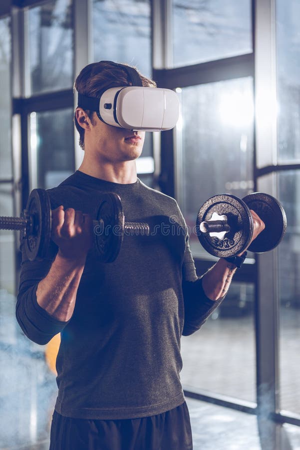 Man in Virtual Reality Headset Exercising with Dumbbells in Gym Stock ...