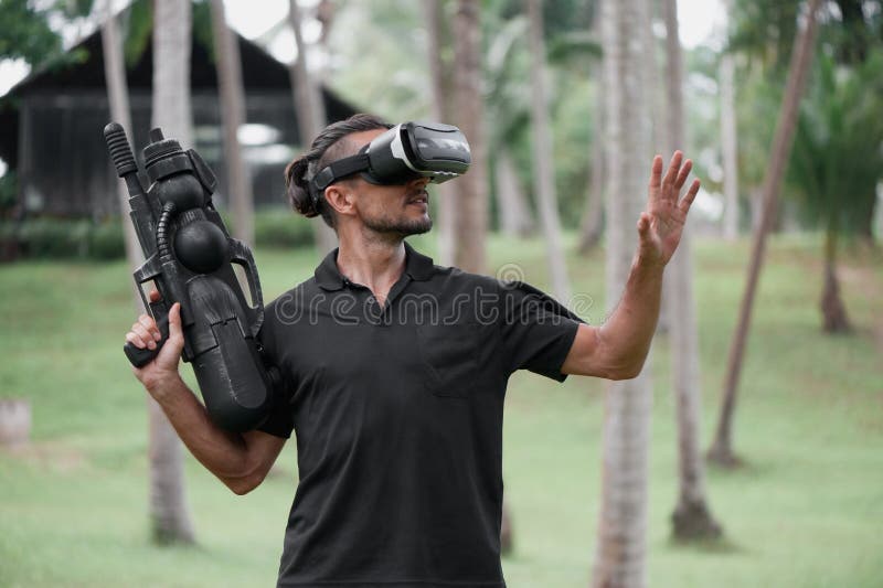 Man in Virtual Reality Headset Playing Video Game Outdoors Stock Photo ...