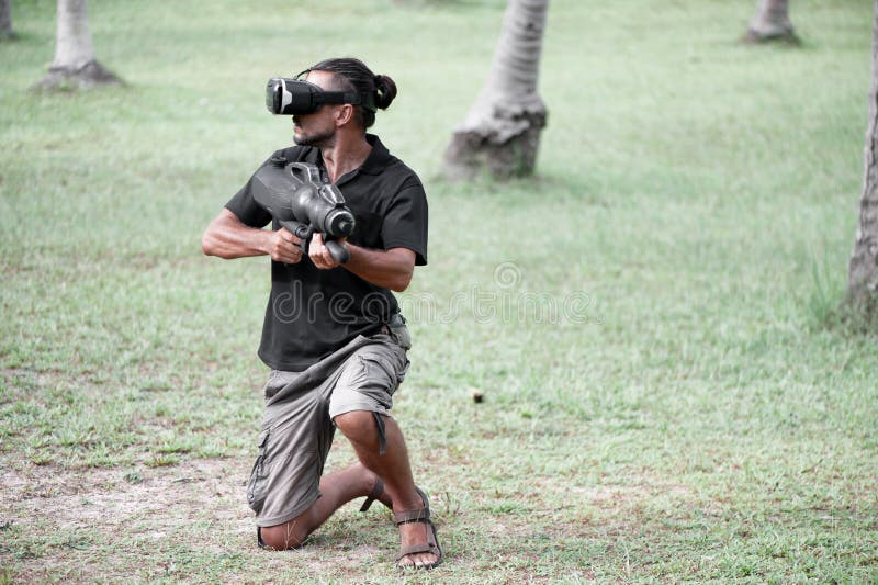 Man in Virtual Reality Headset Playing Video Game Outdoors Stock Photo ...