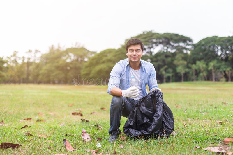 Man Volunteer Pick Garbage Bottle Plastic Clean Up Environment in Green ...