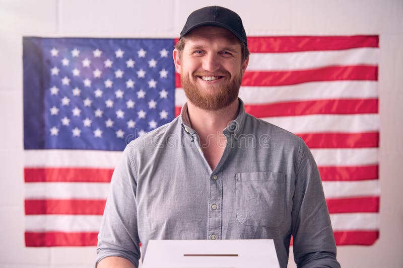 Man Voting in Front of American Flag Stock Photo - Image of freedom ...