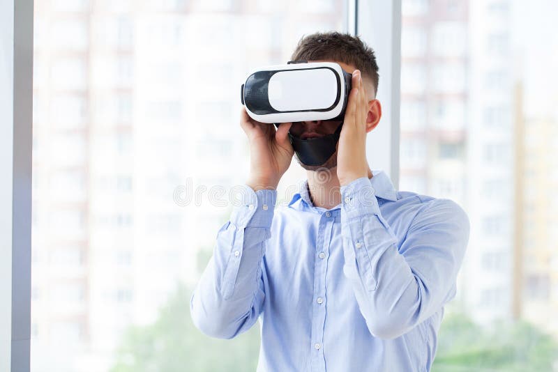 Man in VR Headset Trying To Touch Objects in Virtual Reality Stock ...