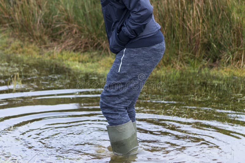 Man Wadding through Water Wearing Wellington Boots Stock Photo - Image ...
