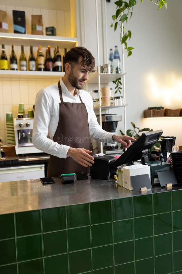 Man Waiter Working in Coffee Shop Using Terminal while Standing at ...