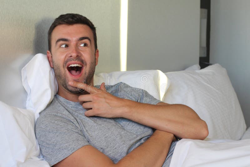 Man waking up happy in bed stock photo. Image of handsome - 121561004