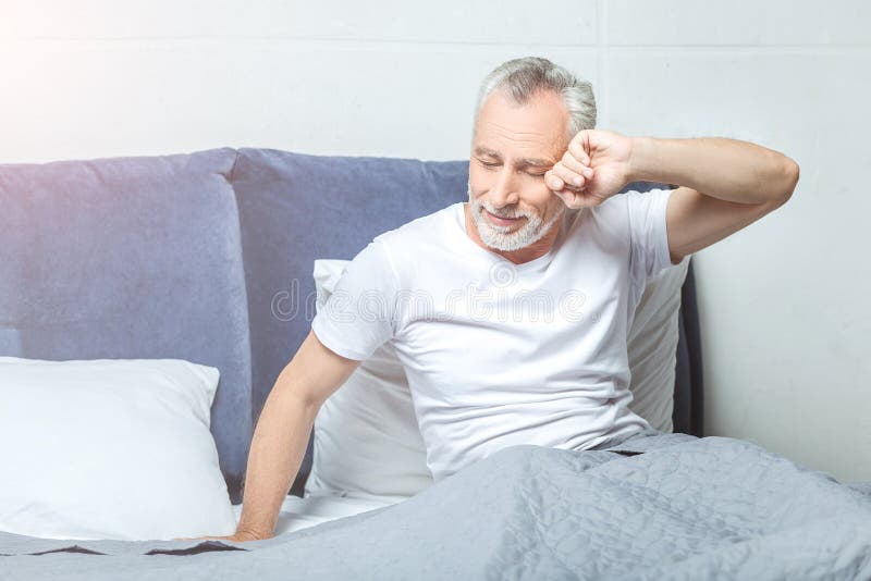 Man waking up n the bed stock image. Image of adult - 137064987