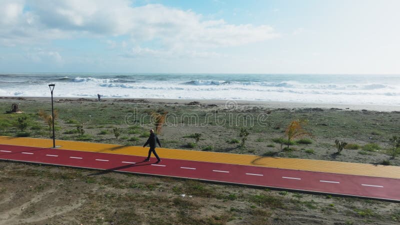 Man Walk in Front of the Angry Sea Stock Footage - Video of coastline ...