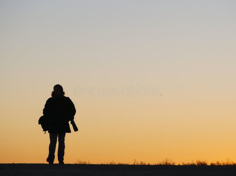 Man Walking Along the Road, Backlit at Sunset Stock Photo - Image of ...