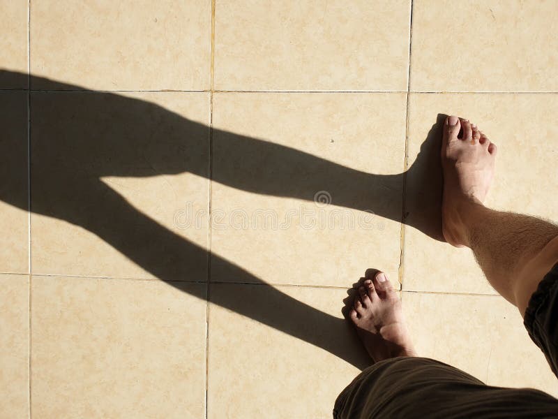 Man`s leg and the shadow stock image. Image of shadow - 220480763