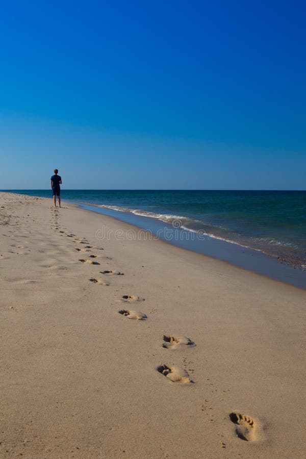 Man Walking on the Beach Leaving Footprints. Stock Image - Image of ...