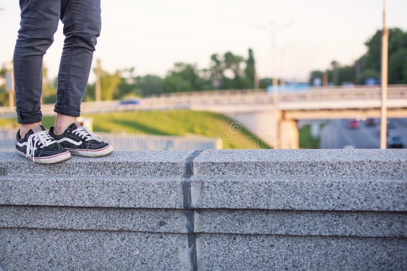 Man Walking on the Concrete Railing of the Bridge Stock Photo - Image ...