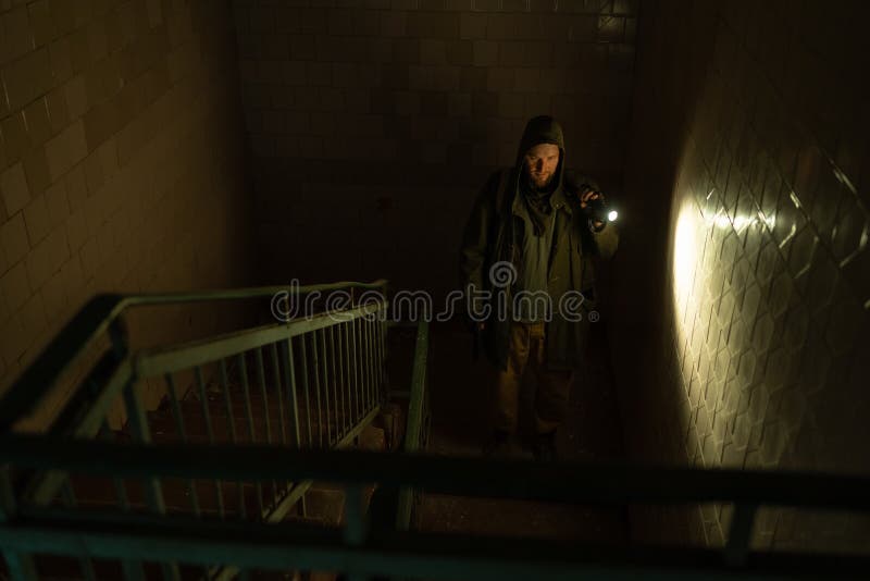 Man Walking in Corridor of the Building Using Flashlight. Nuclear Post ...