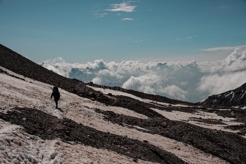 Man Walking on the Dirty Snow Path Looking Down Climbing on the ...