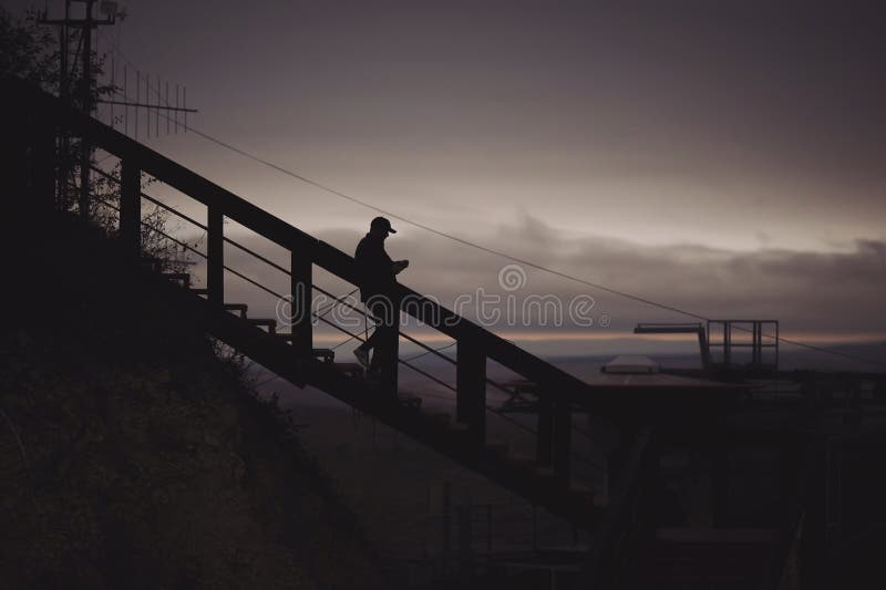 A Man Walking Down the Stairs. Silhouette Walking in the Shadows. Stock ...