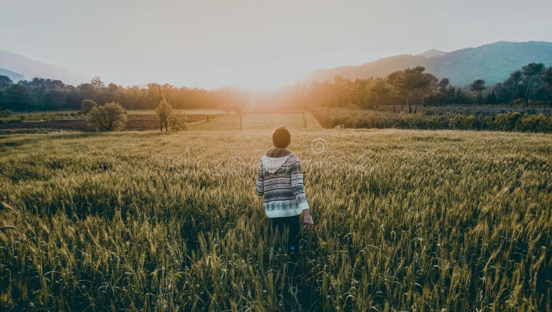Man Walking Through Field Picture. Image: 114892474