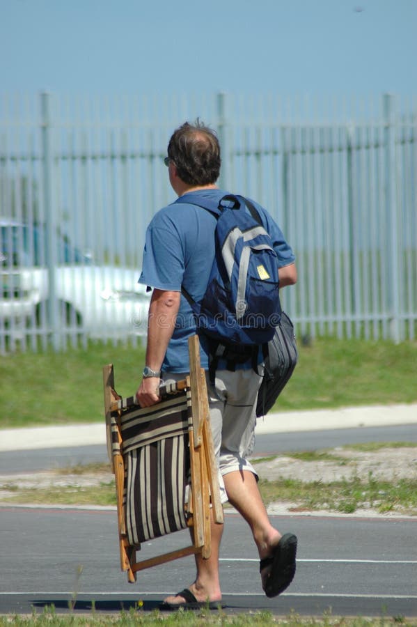 Man Walking with Folding Chair Stock Photo - Image of route, aged: 1484126
