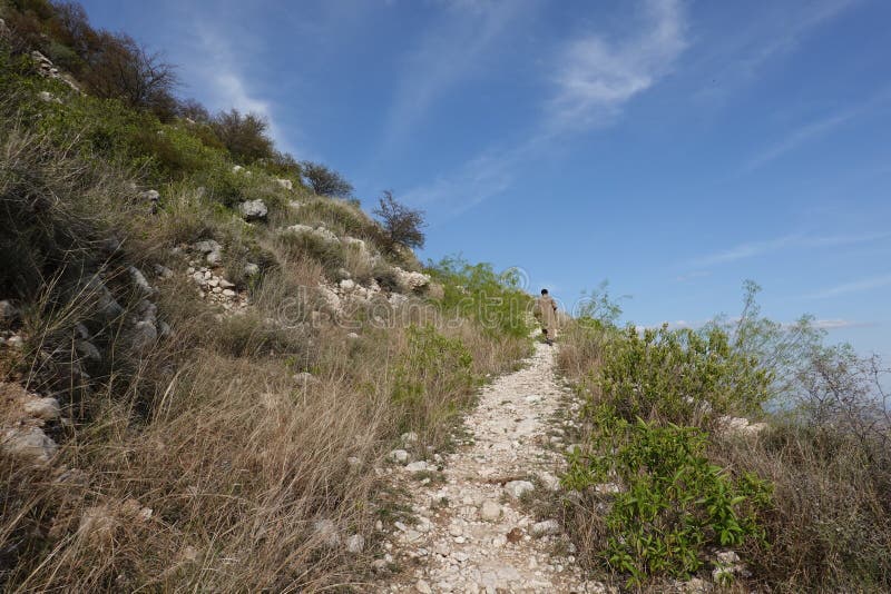 A Man Walking on a Hilly Trek Stock Image - Image of ridge, plateau ...