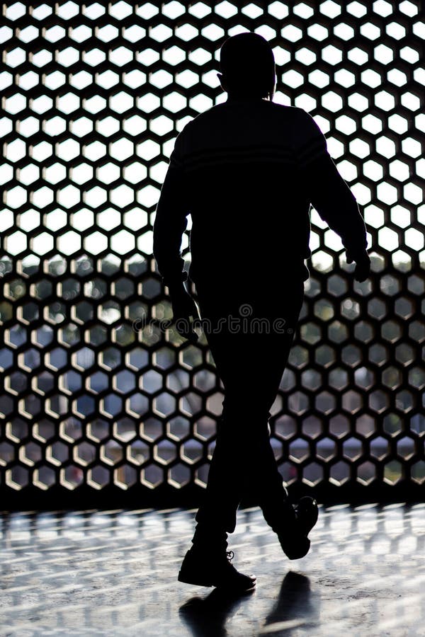 Man Walking Backwards Against Backlighting Stock Image - Image of ...