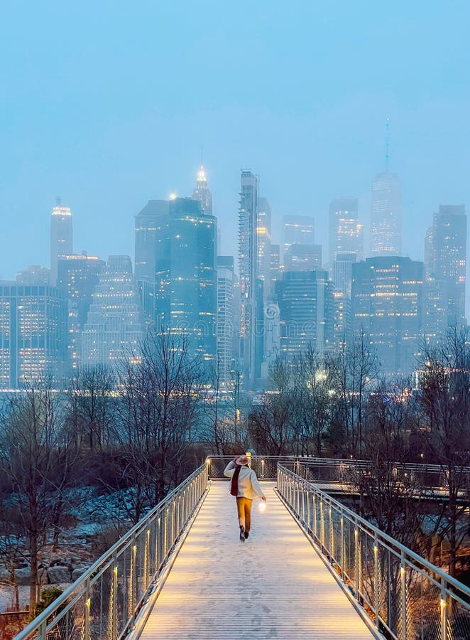 Man Walking on an Illuminated Bridge with Evening Lightful Urban ...