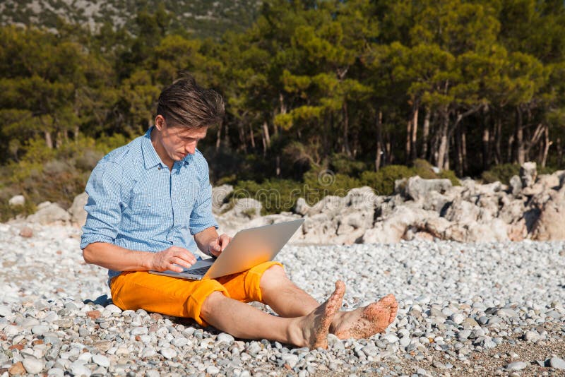 Man Walking with Laptop Computer by the Sea Coast Stock Photo - Image ...