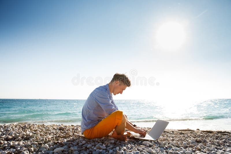Man Walking with Laptop Computer by the Sea Coast Stock Photo - Image ...