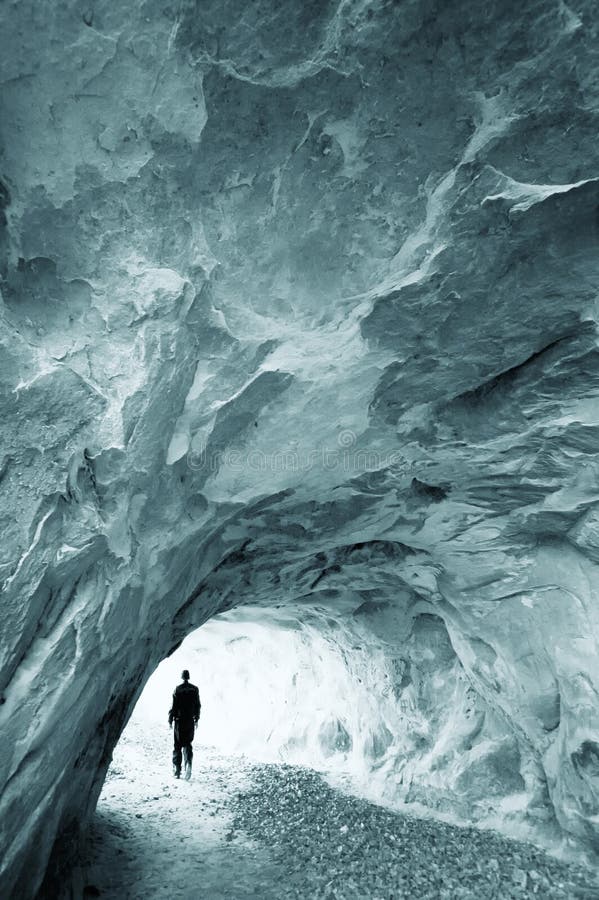 Man walking out of a cave stock image. Image of geologic - 17824441
