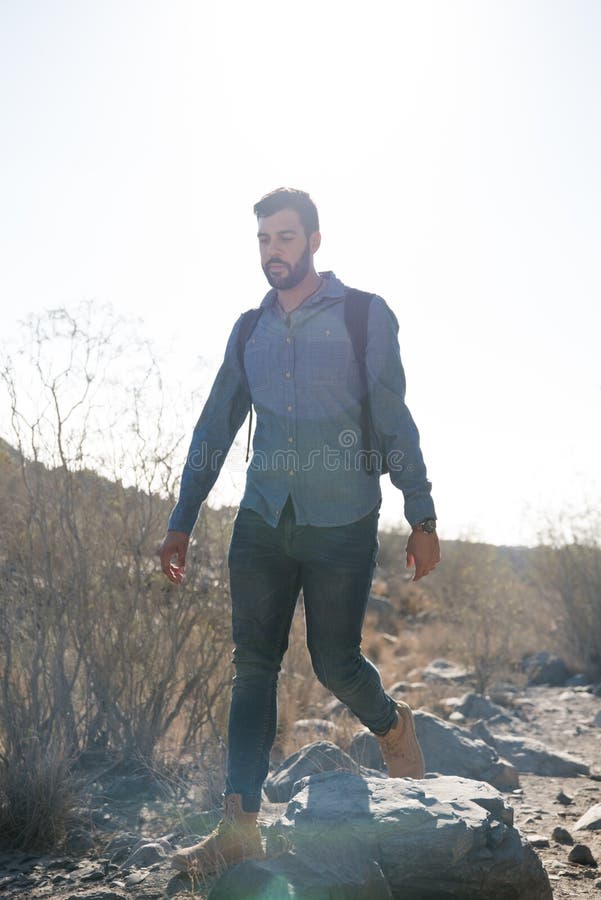 Man Walking Over Rocks in the Desert Stock Photo - Image of adult ...
