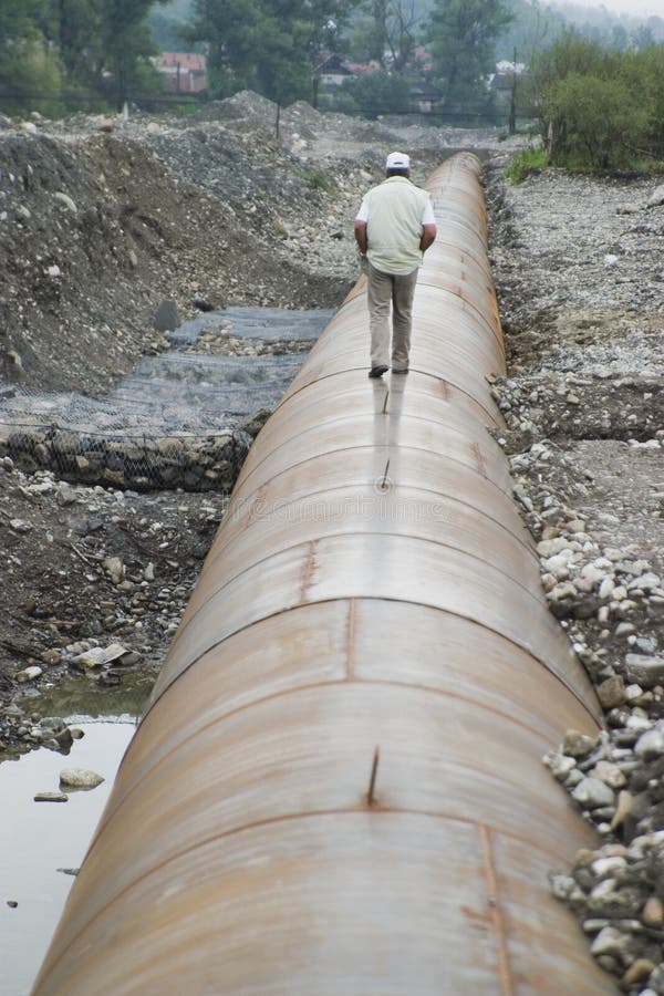 Man walking on pipeline stock photo. Image of inspecting - 3842352