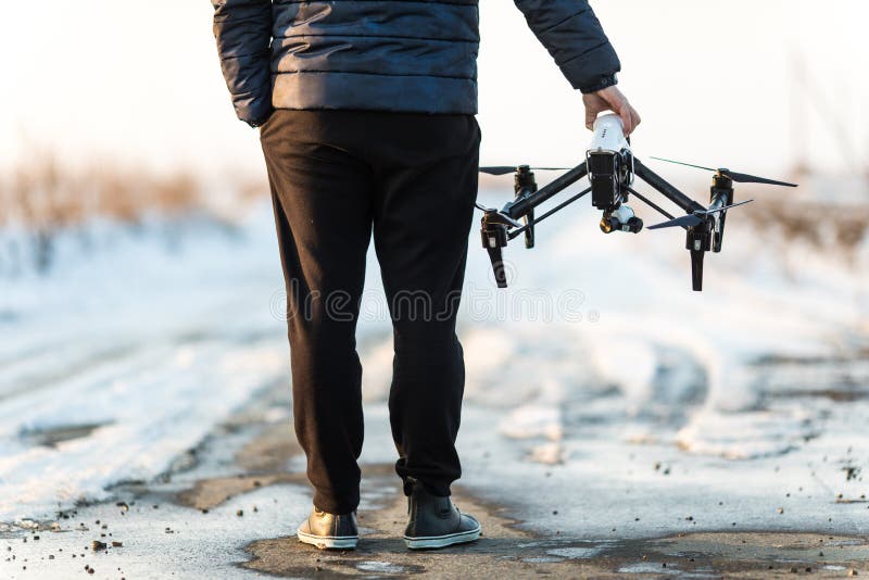 Man Walking and Preparing White Drone with Digital Camera for Flying ...