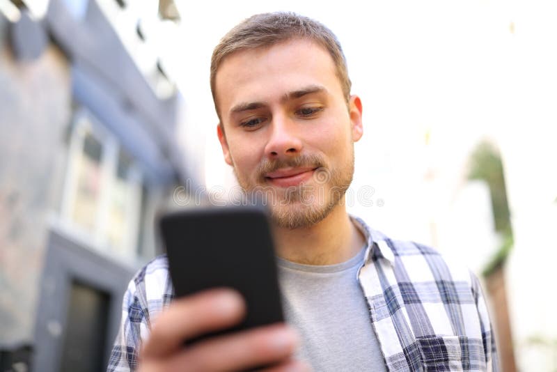 Man Walking in the Street Using a Smart Phone Stock Photo - Image of ...