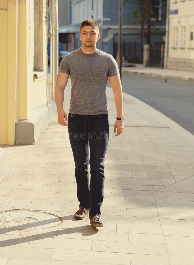 Man walking at the street stock photo. Image of person - 76409870