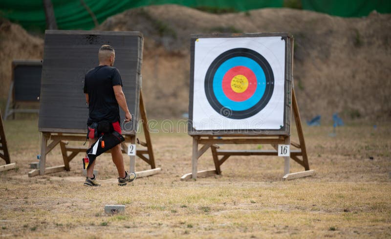 A Man is Walking Towards a Target with a Bow and Arrow Stock Photo ...