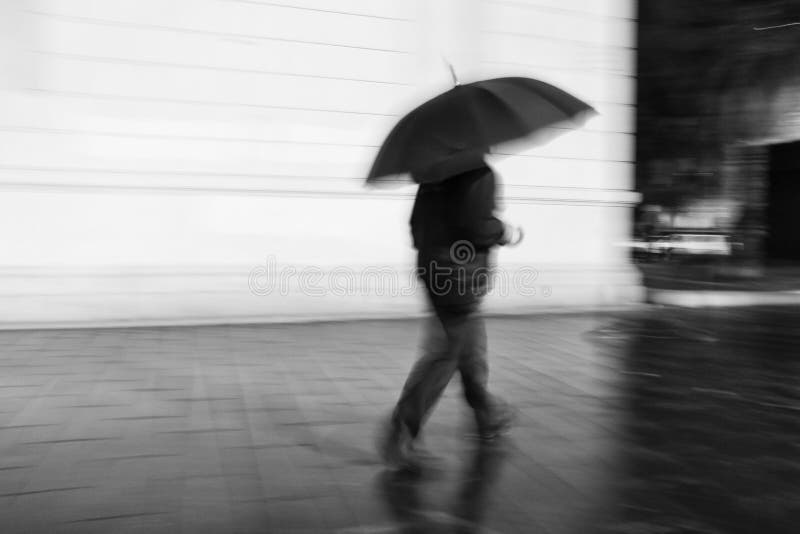 Lonely Man Walking In Rain