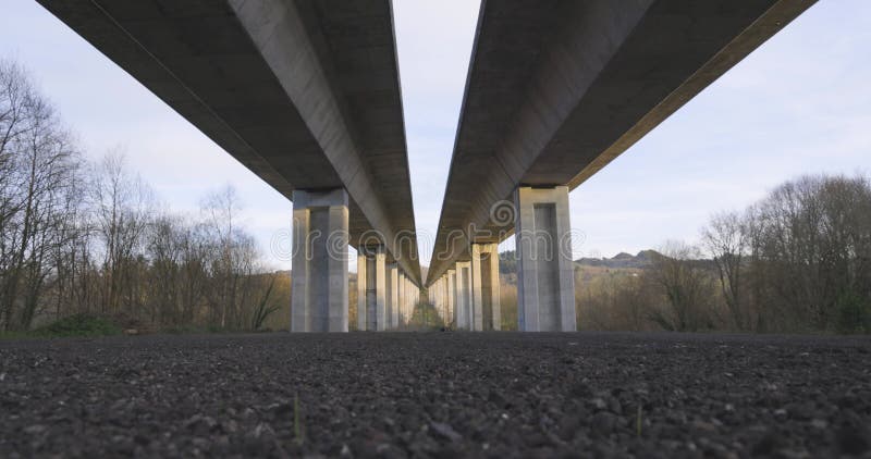 Man Walking Underneath Highway Bridge Underpass Structure with Concrete ...