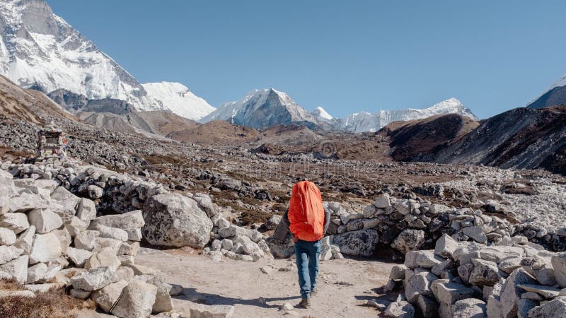 Man is Walking Up a Mountain Path while Carrying Multiple Stones. Stock ...