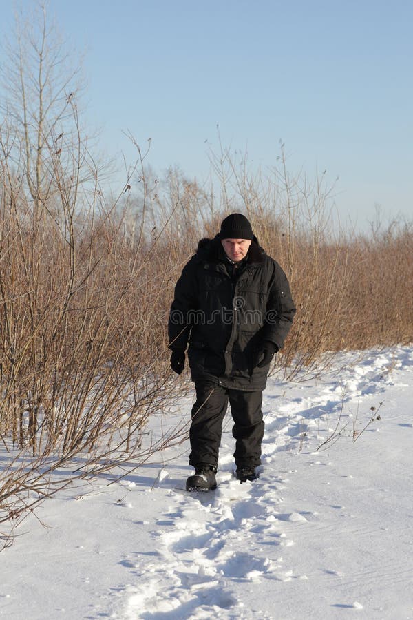 Man walking on winter path stock image. Image of frozen - 23069247