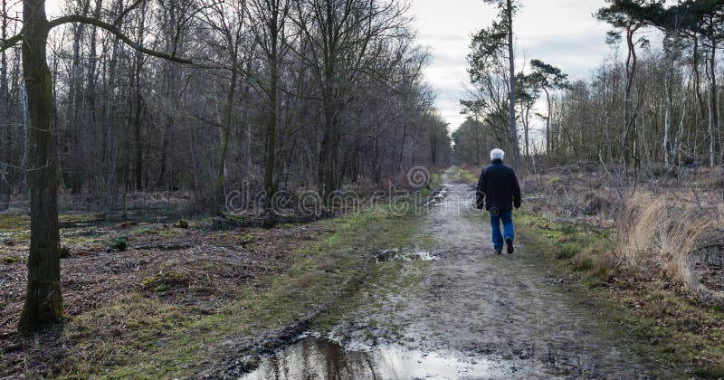 Man Walking Alone On Desolate Landscape Stock Image - Image of alone ...