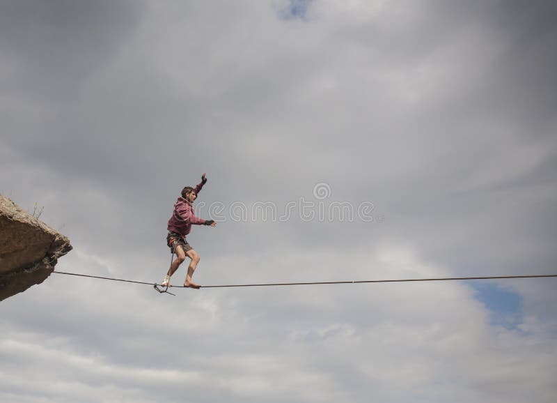 A Man Walks Down Slackline. Stock Photo - Image of high, fear: 59480330