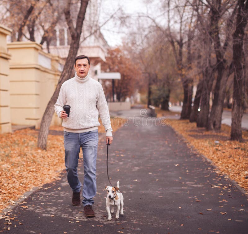 Man walks with his dog stock photo. Image of background - 200189864
