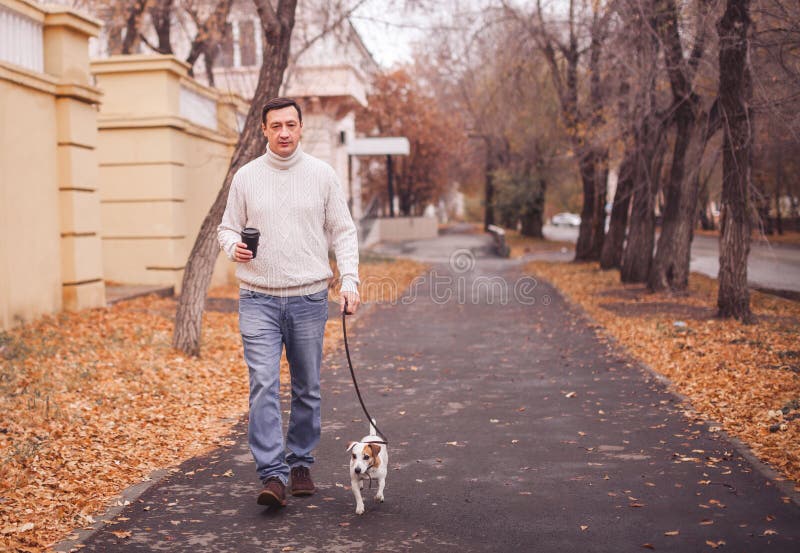 Man walks with his dog stock photo. Image of beard, adult - 228128872