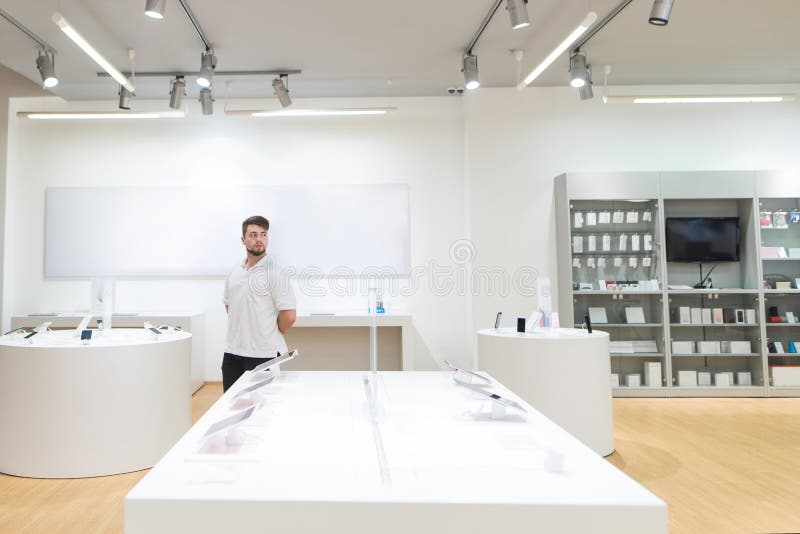 Man Walks on a Light Modern Technology Store. Choosing Gadgets in the ...