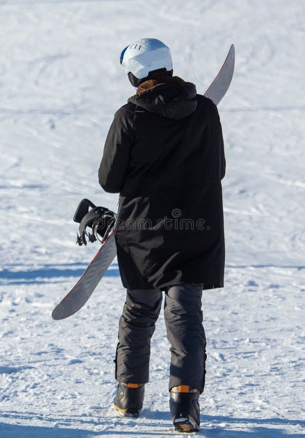 A Man Walks with a Snowboard in His Hands. Stock Photo - Image of ...