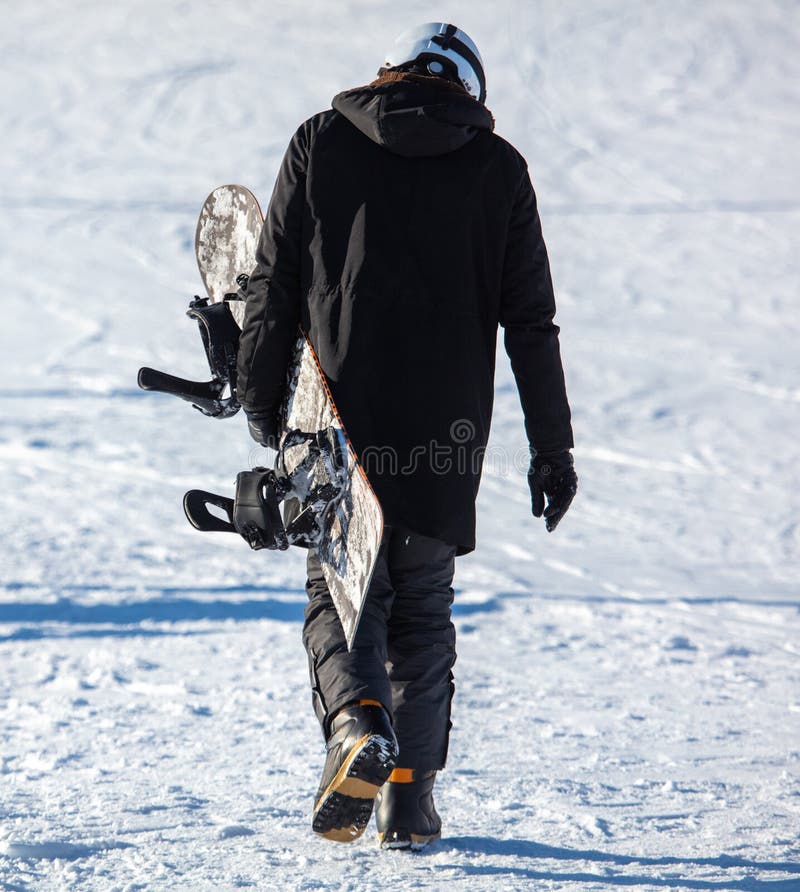 A Man Walks with a Snowboard in His Hands. Stock Photo - Image of ...