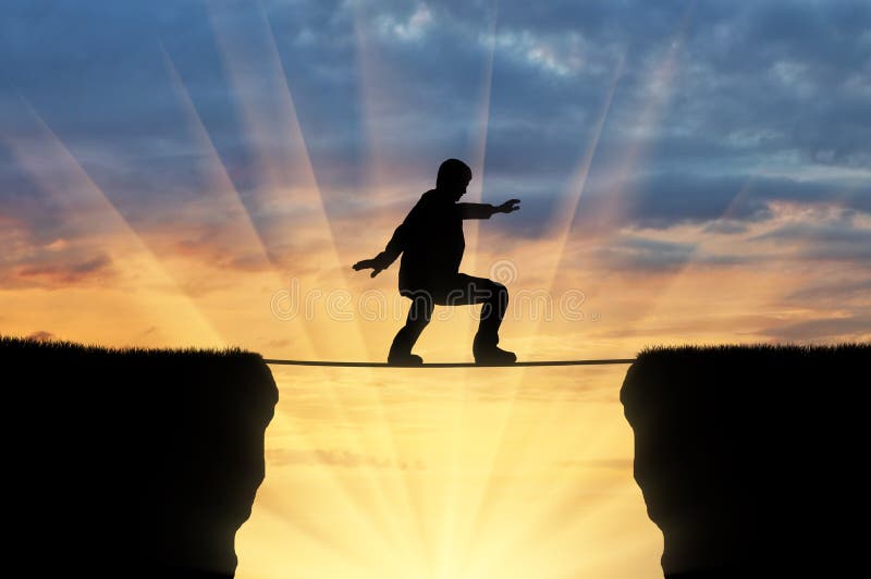 Man Walks on a Tightrope Over a Cliff Stock Photo - Image of ...