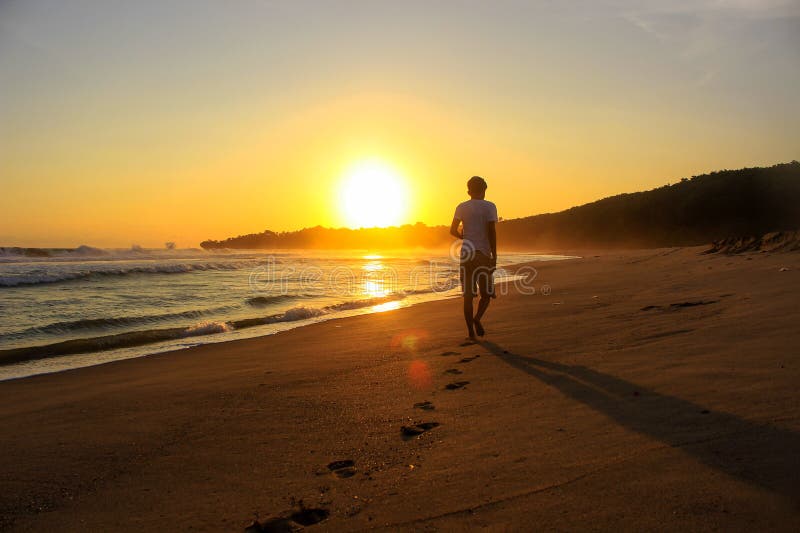 A Man Walks Toward the Setting Sun Stock Photo - Image of lifestyle ...