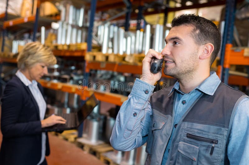 Man Warehouse Worker with Phone Stock Photo - Image of warehouse, phone: 336983406